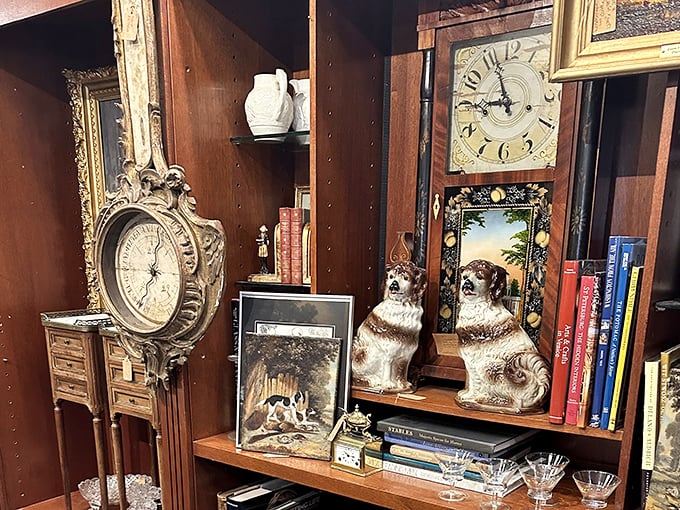 Timepieces and canine companions frozen in porcelain—because nothing says "refined collector" like ceramic dogs guarding your antique clocks.