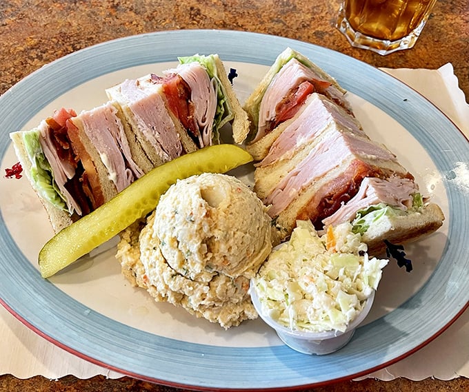 The club sandwich—architecture you can eat, with layers so perfectly stacked they'd make Frank Lloyd Wright nod in approval.