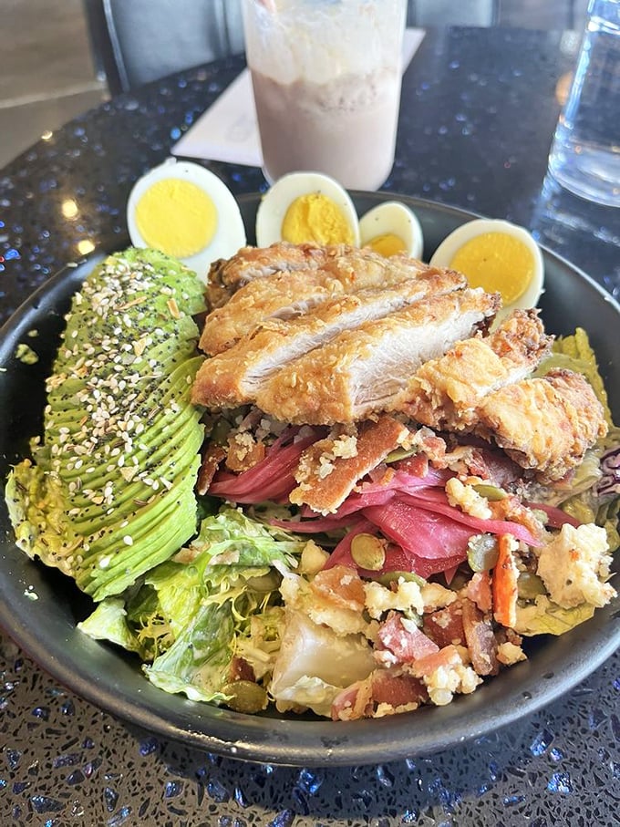 This isn't just a salad—it's a strategic arrangement of avocado, crispy chicken, and hard-boiled eggs that makes eating greens feel like a reward.