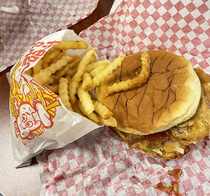 The classic combo—sandwich, fries, and anticipation—arranged on that iconic red-checkered paper that signals good things are about to happen.