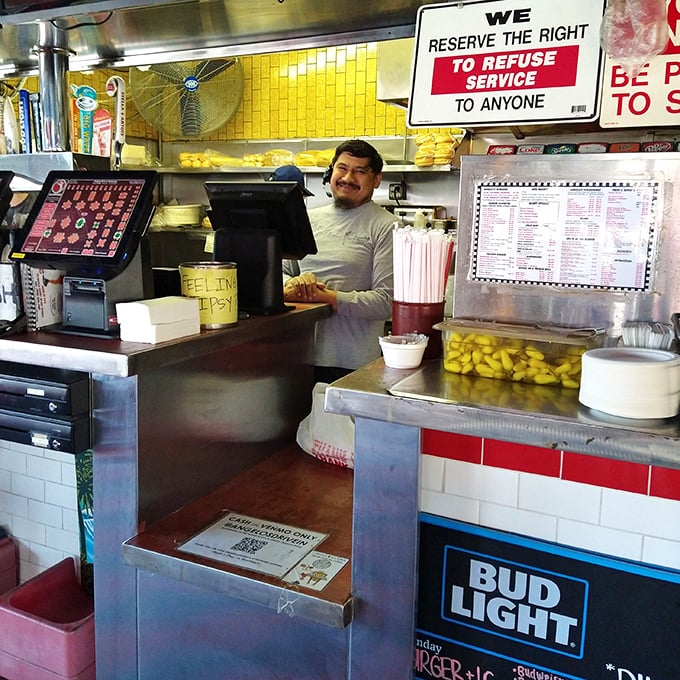 Behind the counter, where burger magic happens daily, staff work with the precision and efficiency that only comes from genuine experience.