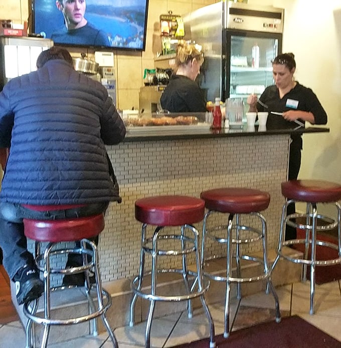 Classic diner counter seating – where solo diners find community and everyone gets a front-row view of short-order choreography.