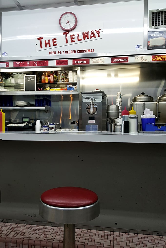 The sign says it all: "OPEN 24/7 CLOSED CHRISTMAS"—because even burger joints deserve one day off, and that red stool is calling your name.