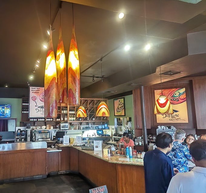 The counter area buzzes with morning energy—colorful pendant lights hanging like exclamation points above conversations and coffee refills.