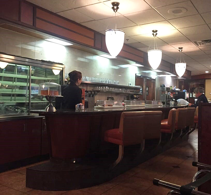 The counter seating—where solo diners become temporary family and servers perform the ballet of plates and coffee refills with practiced precision.