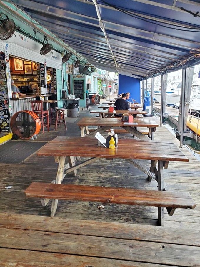The outdoor deck—where salt air seasons every bite and the boundary between restaurant and marina blurs into Keys perfection.