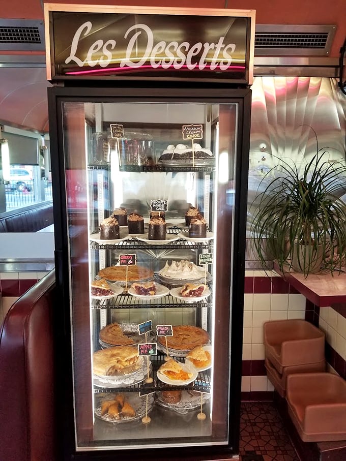 The dessert case—a glass-enclosed museum of temptation where willpower goes to die and diet plans are postponed until tomorrow.