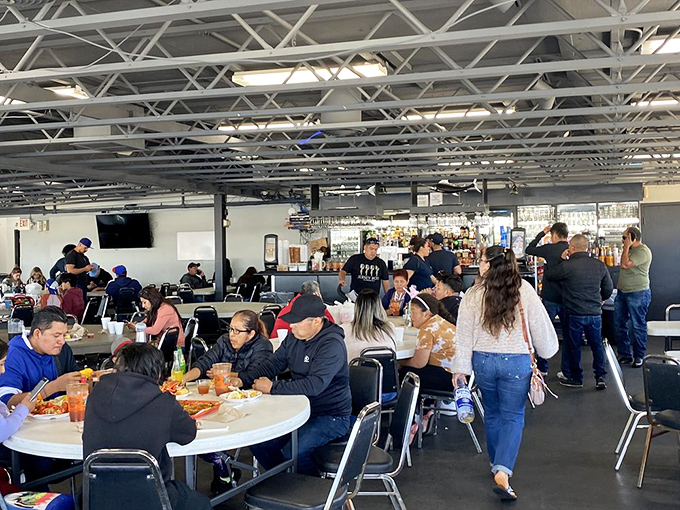 The dining area buzzes with the energy of shared seafood experiences—where strangers become temporary friends united by the universal language of "pass the tartar sauce."