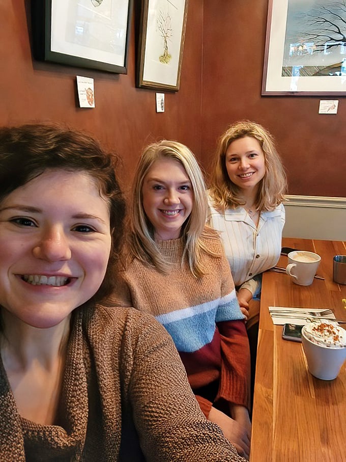 Happy diners sharing coffee and conversation—the universal language of "we found something good here." Some friendships are measured in coffee cups.