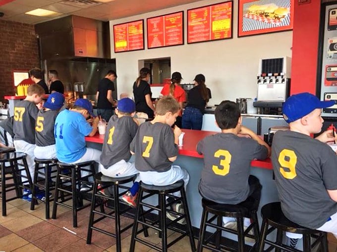 Little leaguers at the counter prove that burger appreciation starts young. Those numbered jerseys may change, but their burger orders probably won't.