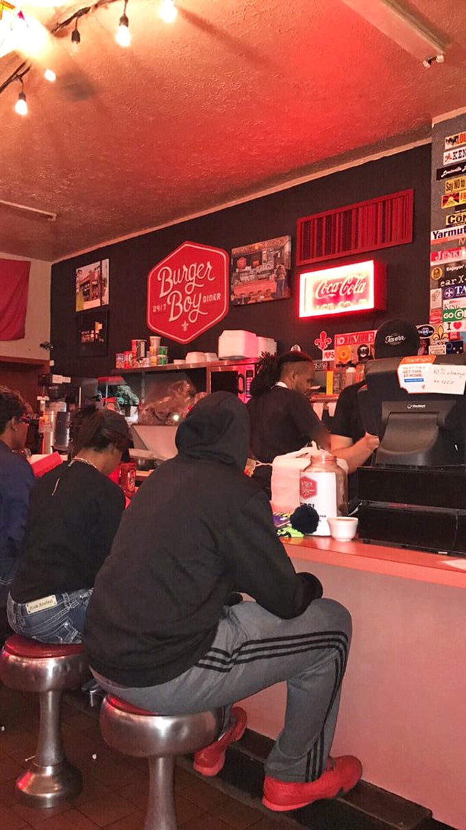 Counter seating where strangers become friends over shared appreciation for properly melted cheese and perfectly grilled beef.