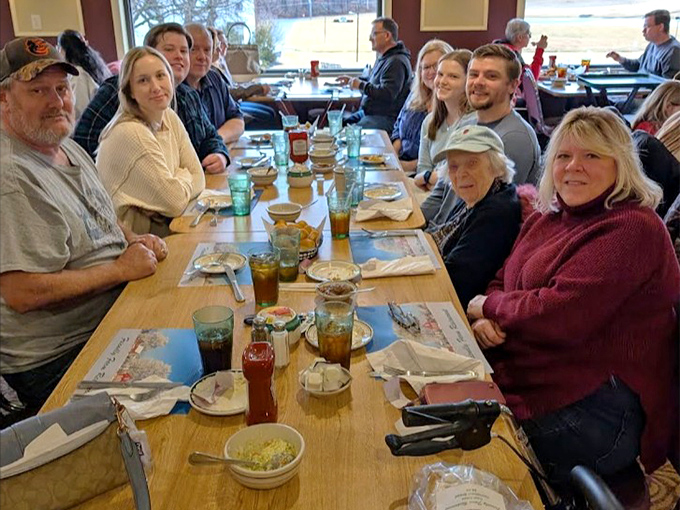 Happy diners in their natural habitat—surrounded by comfort food and zero regrets.