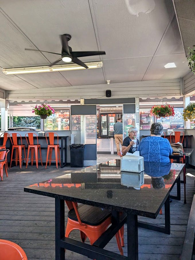 The outdoor dining area: where strangers become friends over shared condiments and the mutual understanding that great food needs no fancy surroundings. 
