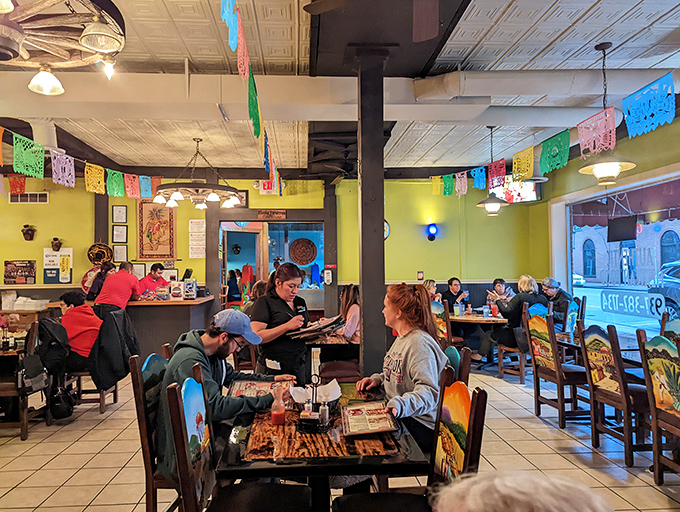 The dining room buzzes with the universal language of good food. Those colorful papel picado banners overhead are basically happiness flags.