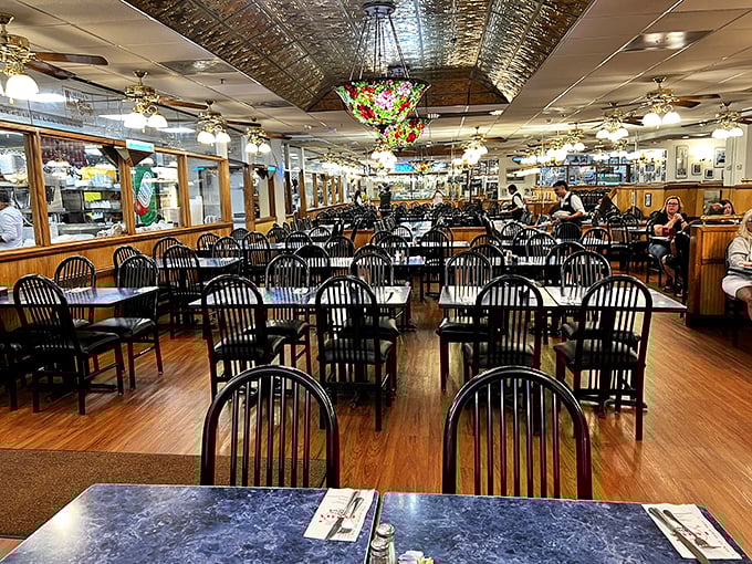 The dining room awaits with the promise of communal feasting – where strangers become friends united by the universal language of enormous sandwiches.