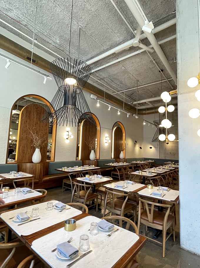 Elegant simplicity defines the dining space. Those pendant lights aren't just illuminating tables—they're spotlighting culinary performances worthy of a standing ovation.
