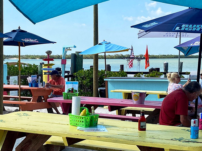 Colorful picnic tables with million-dollar views – no dress code required, just an appetite for fresh seafood and sunshine.