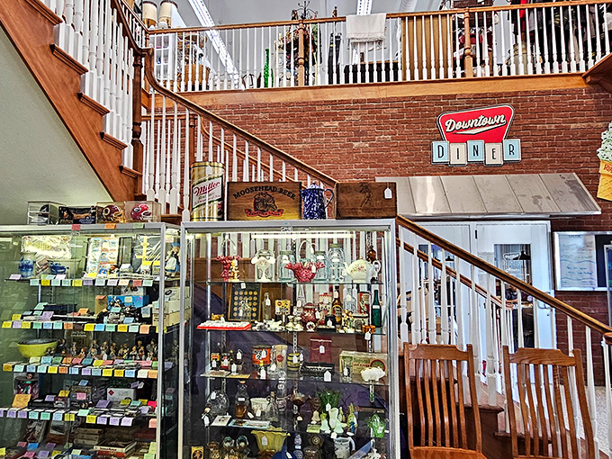 The staircase area combines the thrill of the hunt with the comfort of nostalgia – display cases filled with memories under that playful Downtown Diner sign.