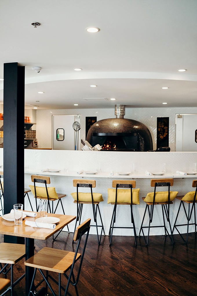 Front-row seats to the pizza action—watching your dinner emerge from that gleaming dome oven adds anticipation to the appetite.