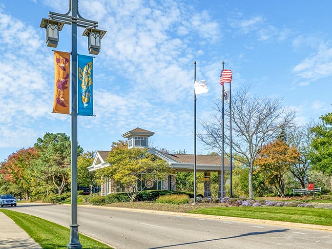 Small-town charm meets resort living! The beautifully maintained entrance area sets the tone for a community that takes pride in every detail, right down to the seasonal banners.