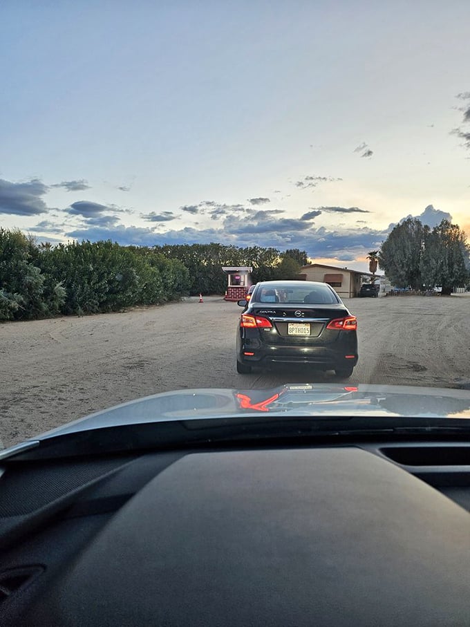 The anticipation builds as you follow the car ahead, inching closer to your evening under the stars.