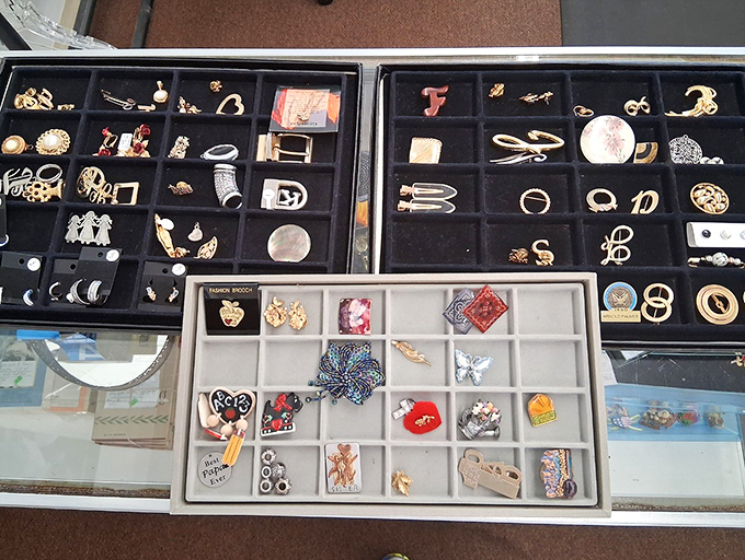 Treasure chest of vintage pins, brooches and rings—each tiny compartment holds someone's former statement piece waiting for its comeback tour.