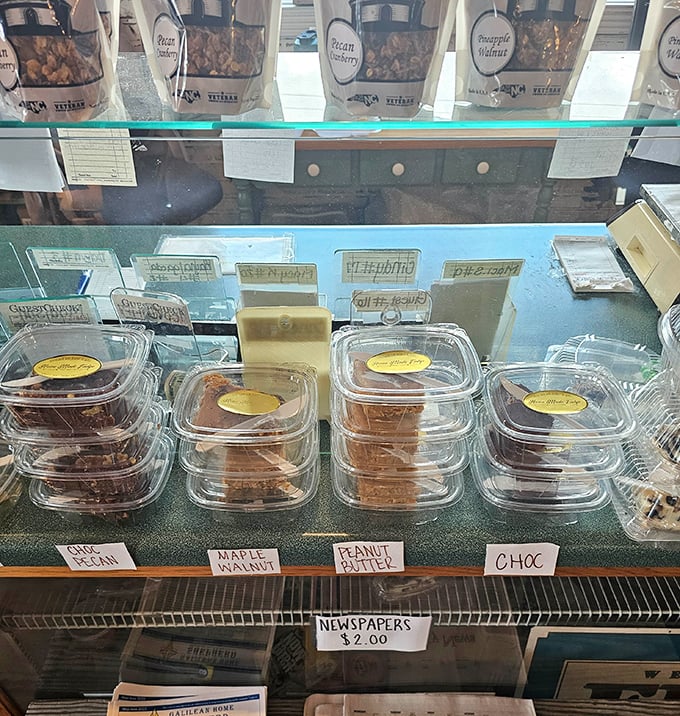 Fudge varieties lined up like sweet soldiers—chocolate, maple walnut, peanut butter—each waiting for their chance to destroy your willpower.