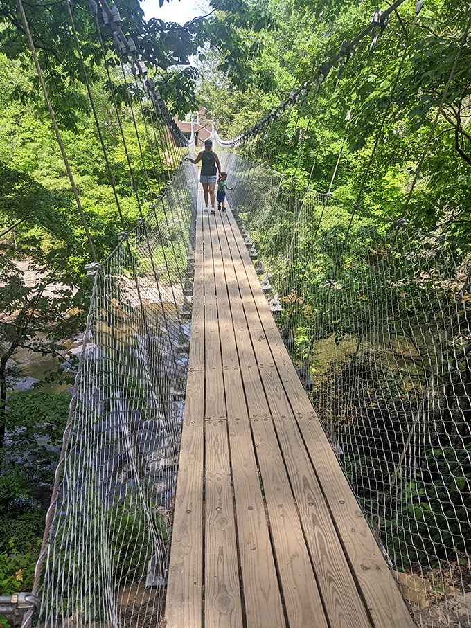 This suspension bridge isn't merely a crossing – it's nature's ultimate trust exercise, swaying gently as you dangle above rushing waters below.