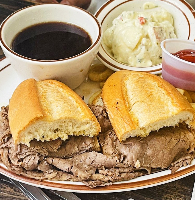 The French dip sandwich—tender roast beef nestled in a pillowy roll with a side of jus so good you'll want to drink it straight.