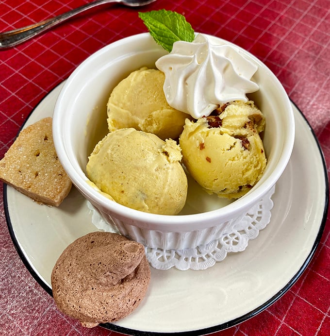 Ice cream served in a proper dish with cookies on the side—because at a supper club, dessert isn't an afterthought but a grand finale.