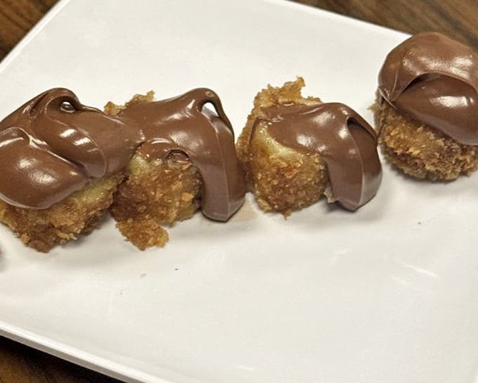 Fried banana with Nutella drizzle – where tropical fruit meets European chocolate in a dessert that should require a passport.