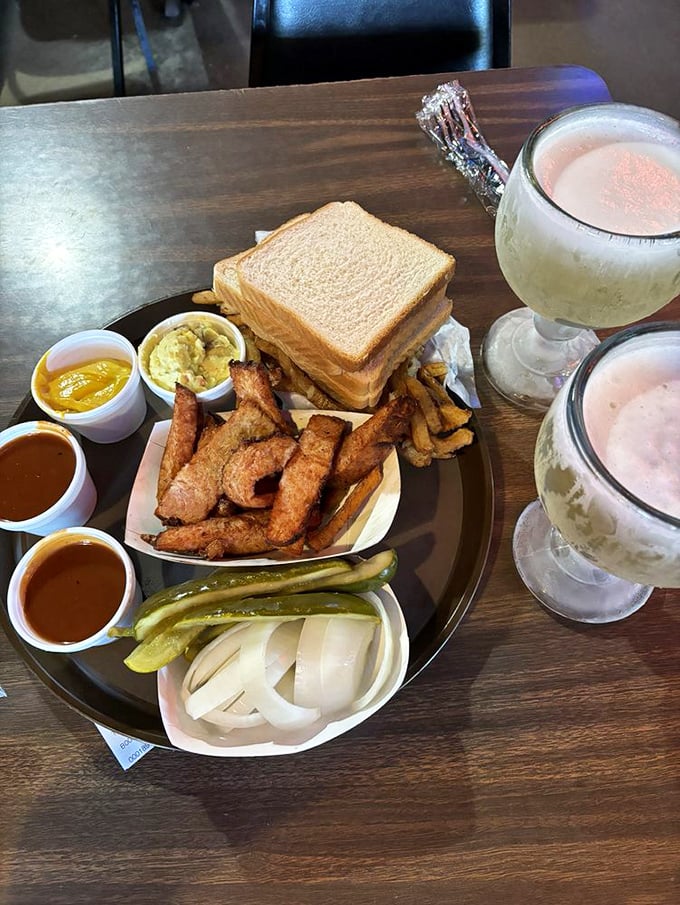A sandwich spread worthy of a diplomatic summit—multiple sauces, perfect pickles, and fries that didn't come from a freezer.