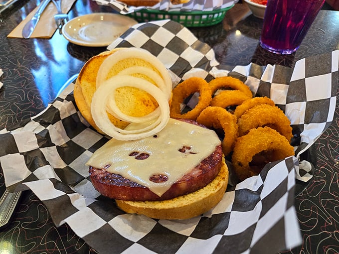 The German Bologna Sandwich arrives with onion rings that could double as edible bracelets. Simple food that respects tradition without being trapped by it.