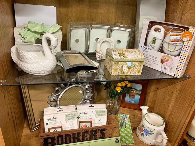 A shelf of possibilities—from ceramic swan planters to silver picture frames waiting to hold new memories. Marie Kondo would not approve of how much joy these spark.