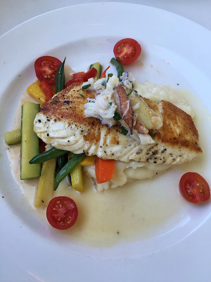 This halibut has found its happy place—nestled among vibrant vegetables in a pool of buttery sauce that's practically drinkable.