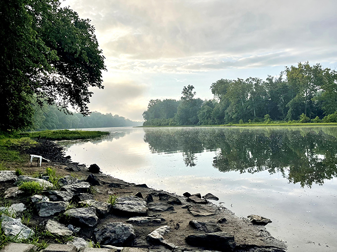 The Potomac River's glassy morning surface mirrors the surrounding trees, offering twice the natural beauty at zero additional cost.