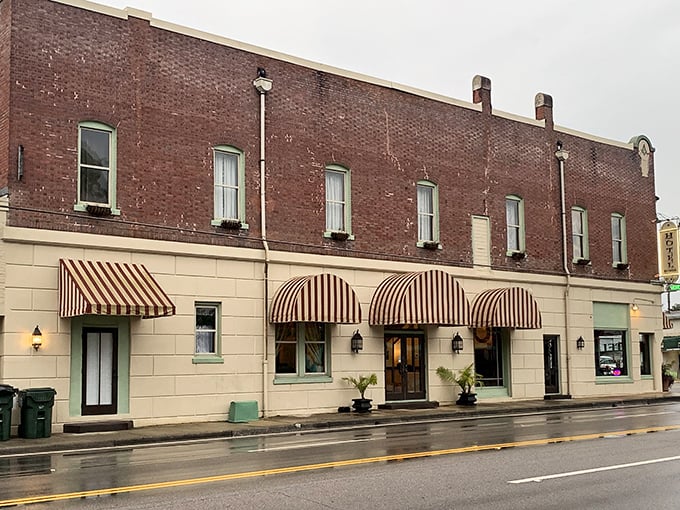 Hotel DeFuniak's striped awnings and historic façade whisper tales of travelers who arrived by steam rather than horsepower.