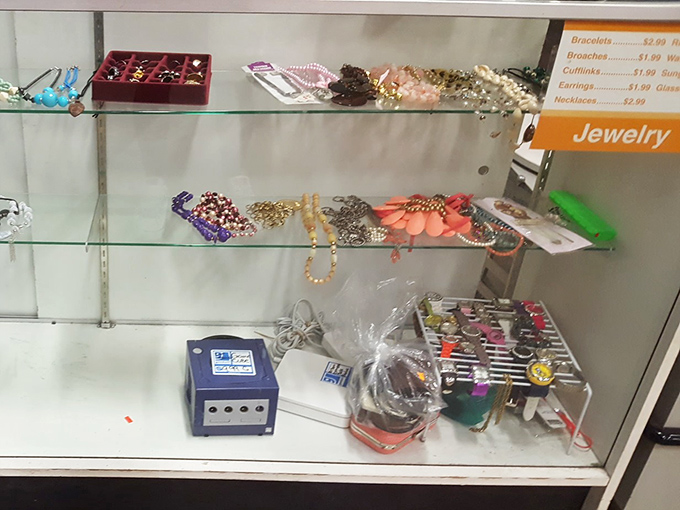Behind glass, costume jewelry awaits its next performance. Those beaded necklaces and vintage brooches aren't just accessories—they're conversation pieces with previous lives.