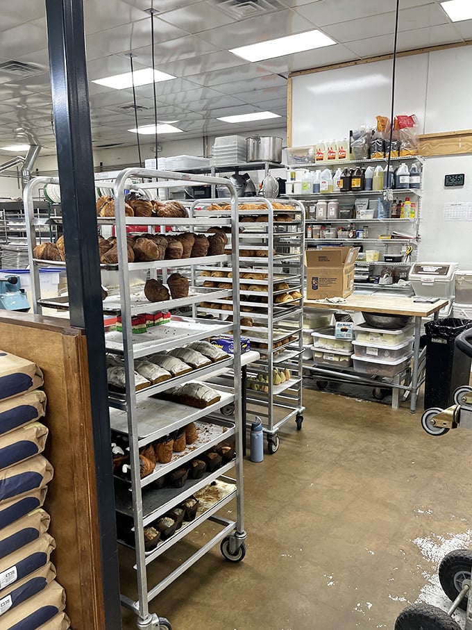 A glimpse into the kitchen reveals the behind-the-scenes magic—racks of freshly baked bread waiting for their moment in the spotlight.