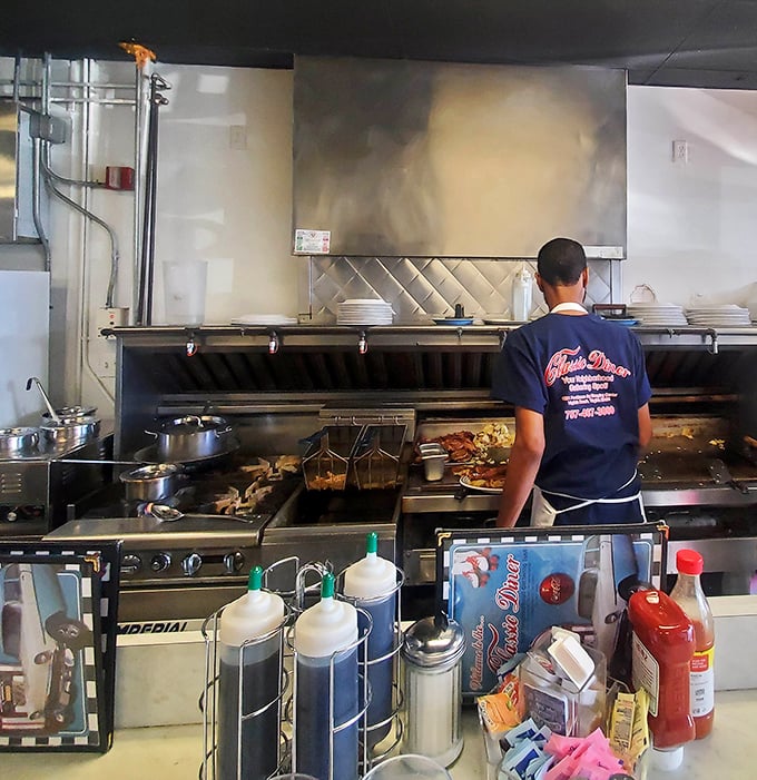 The kitchen ballet is mesmerizing—spatulas flying, bacon sizzling, and short-order cooks performing the timeless choreography of American breakfast.