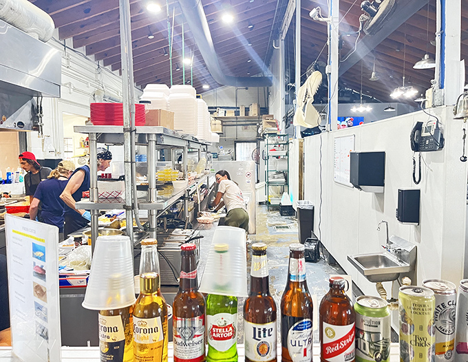 A glimpse into the kitchen where the magic happens. Those bottles in the foreground suggest the staff knows good food deserves good beverages.