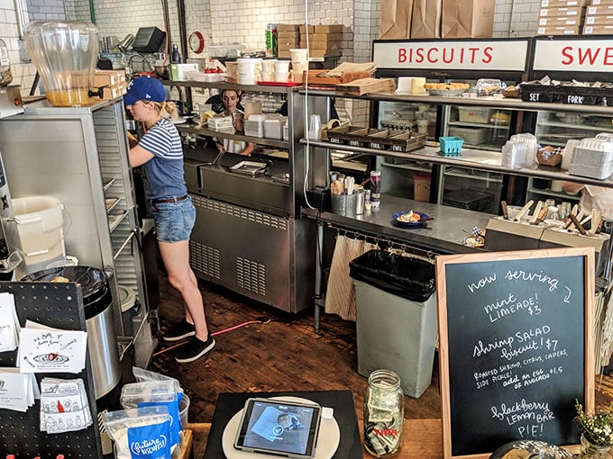 Behind the scenes where flour-dusted wizards work their magic. That chalkboard menu hints at seasonal treasures worth the journey.