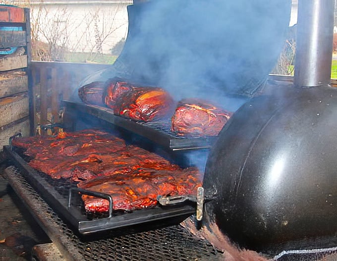 BBQ magic happens here. That smoke isn't just for show—it's the aromatic evidence of patience and craftsmanship in every bite.
