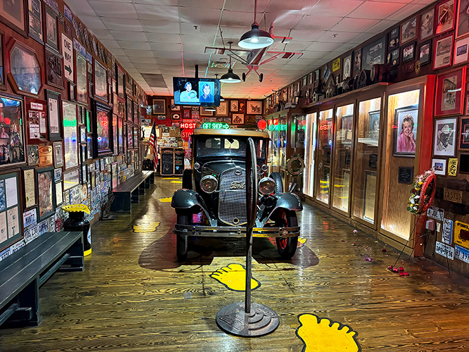 This vintage car parked inside isn't just decoration—it's a time machine to when roadside attractions promised both spectacle and sustenance.