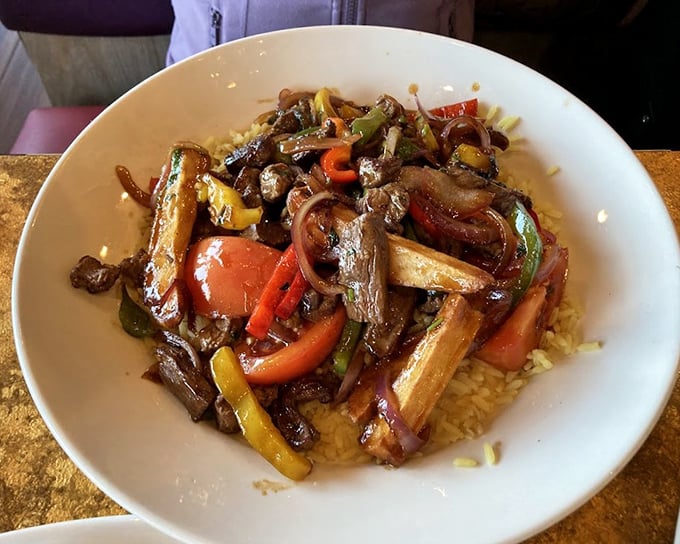 Lomo Saltado brings Peru to New Jersey—tender beef strips dancing with colorful peppers and onions atop a bed of rice. A passport for your palate.