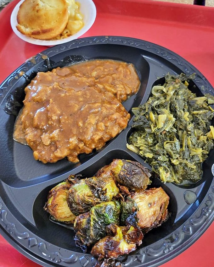 Country-fried steak smothered in gravy with greens and Brussels sprouts—a Southern plate that hugs you from the inside out.
