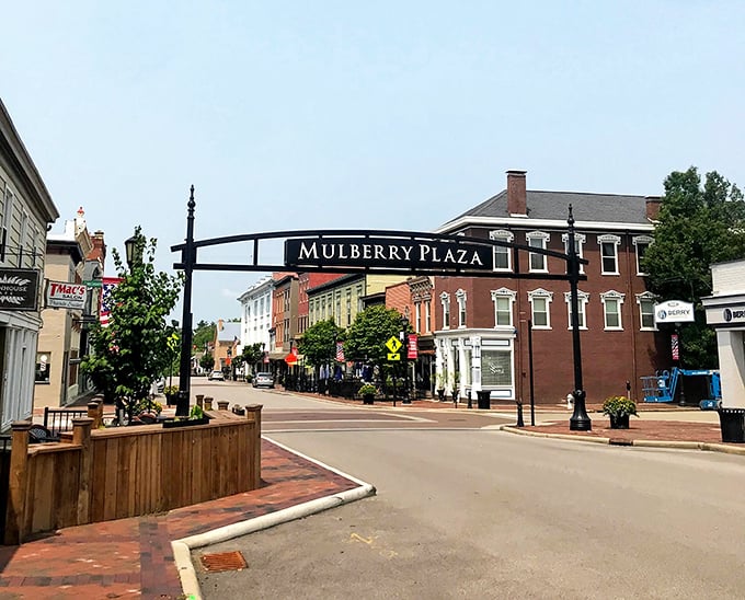Mulberry Plaza's welcoming arch frames a downtown that invites leisurely strolls, window shopping, and genuine small-town connection moments.