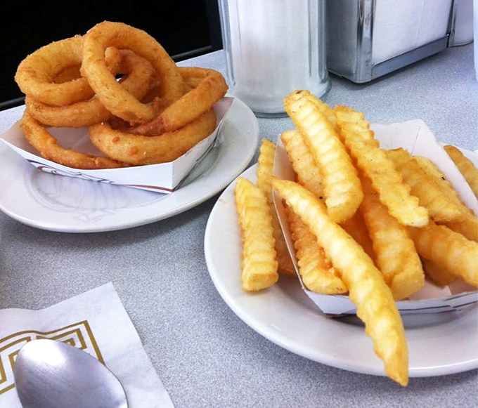 Onion rings and crinkle-cut fries – the dynamic duo of side dishes that have been supporting main courses longer than Batman had Robin.