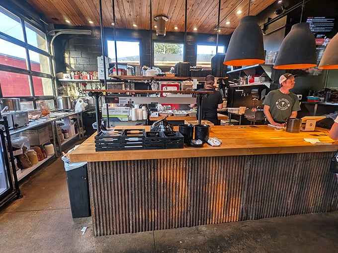 Behind the counter magic where smoke meets meat. The rustic wood and metal aesthetic perfectly frames the serious business of barbecue.