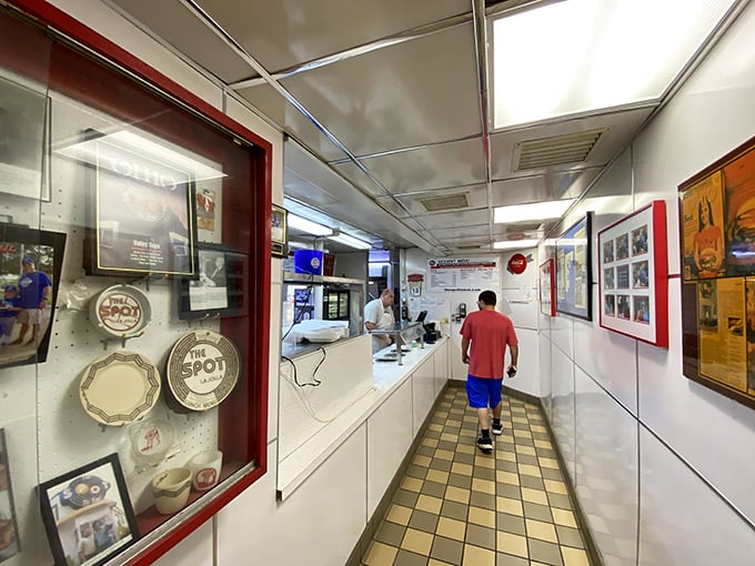 The corridor of comfort – where every framed memory on the wall tells a story about this beloved local institution.